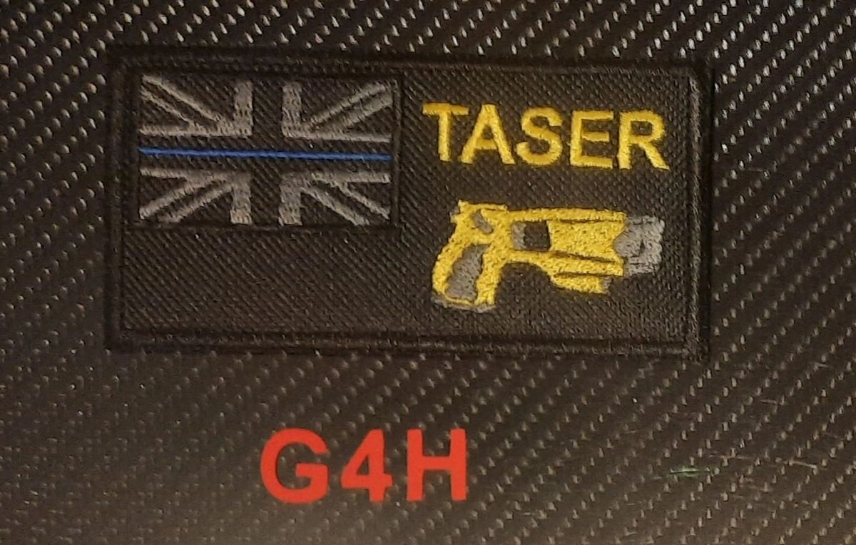 Police TASER with Thin Blue Line UJ flag, velcro patch.