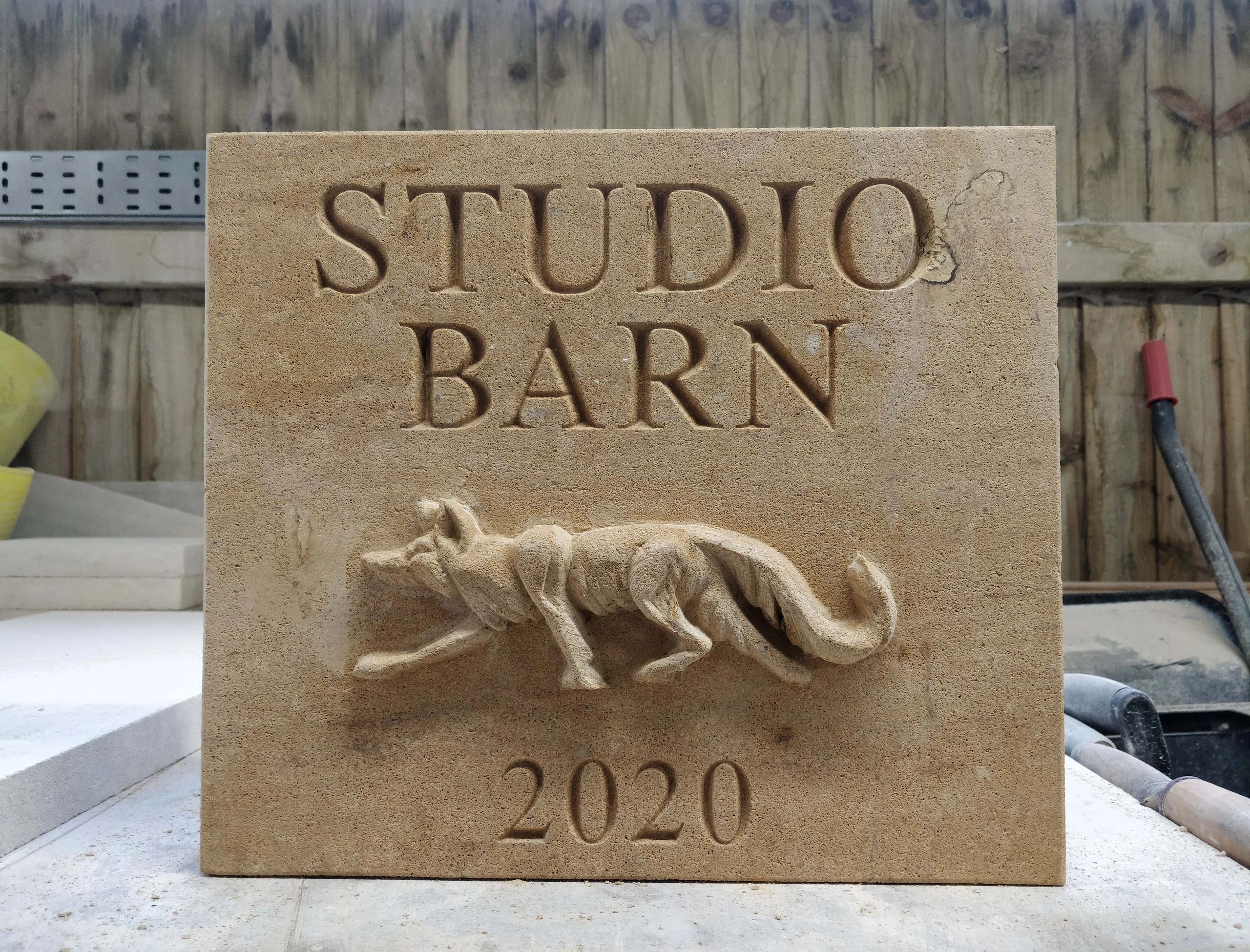 Bass relief carving and letter cutting for a bespoke house sign.