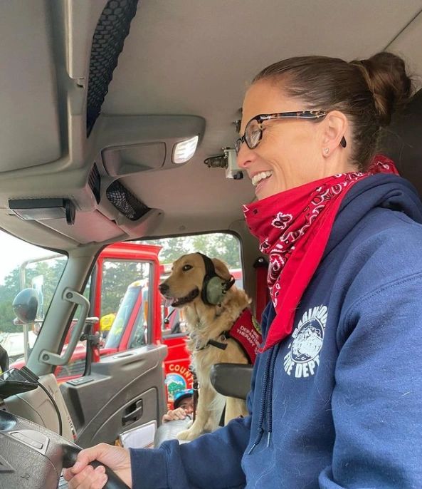 Kerith the golden retriever is offering comfort to fire fighters