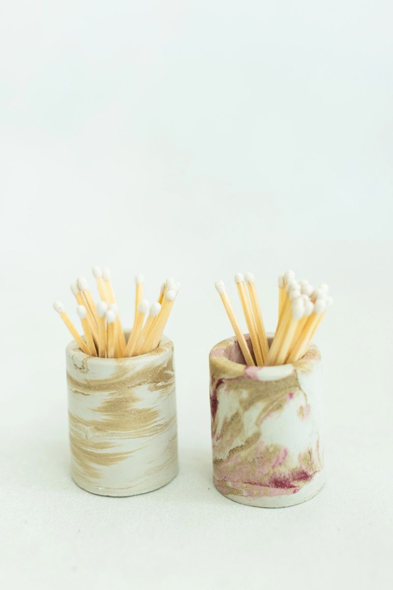 Concrete matchstick holder with striker bottom