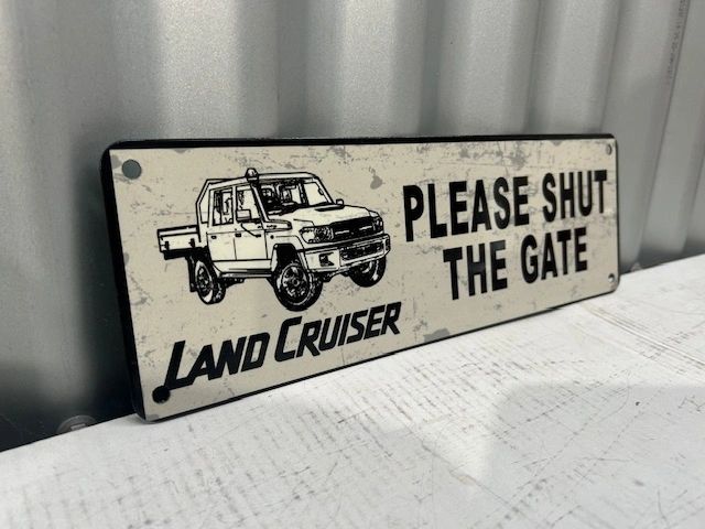 TOYOTA LANDCRUISER SHUT THE GATE 300 MM X 100 MM METAL SIGN