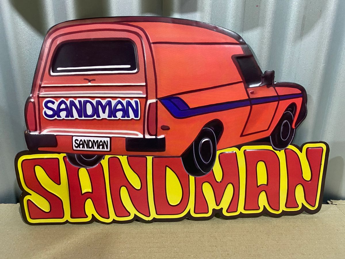 SAND MAN PANEL VAN EMBOSSED METAL SIGN