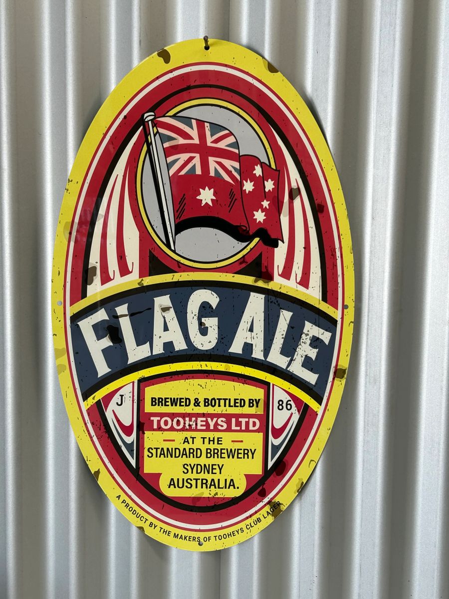 TOOHEYS FLAG ALE OVAL 610 MM X 360 MM METAL SIGN