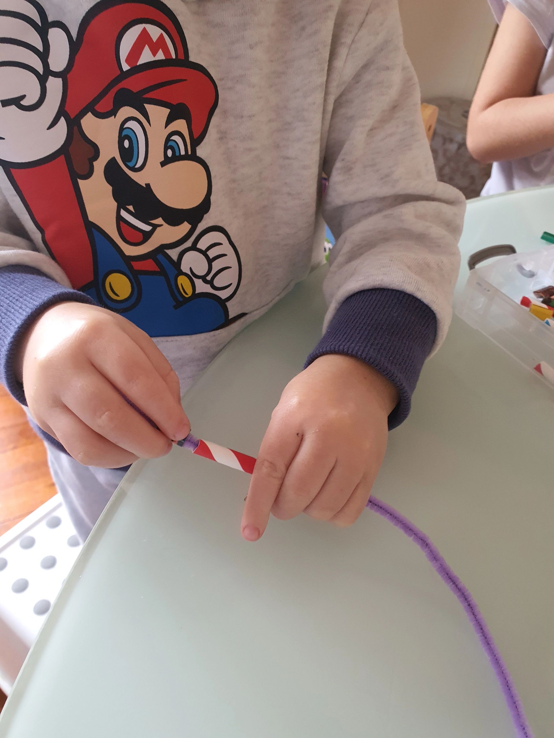 Developing pre-writing and fine motor skills through threading
