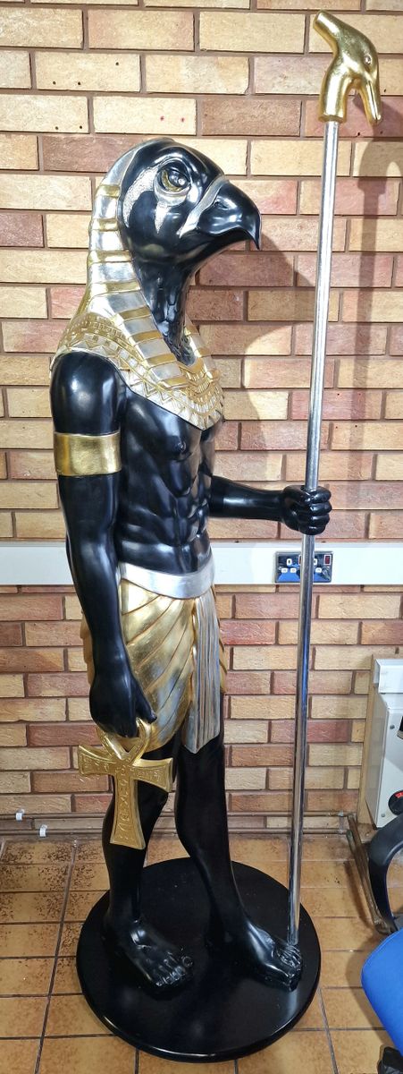 Composite life-size statue of Egyptian God Horus with staff