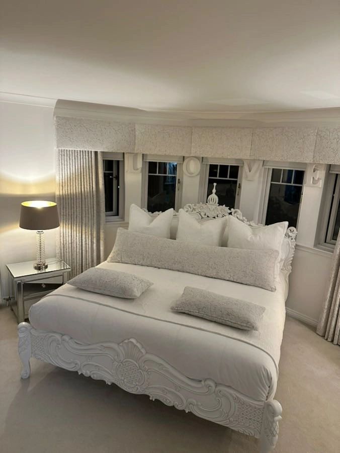 Huge bay window wave curtains and pelmet.