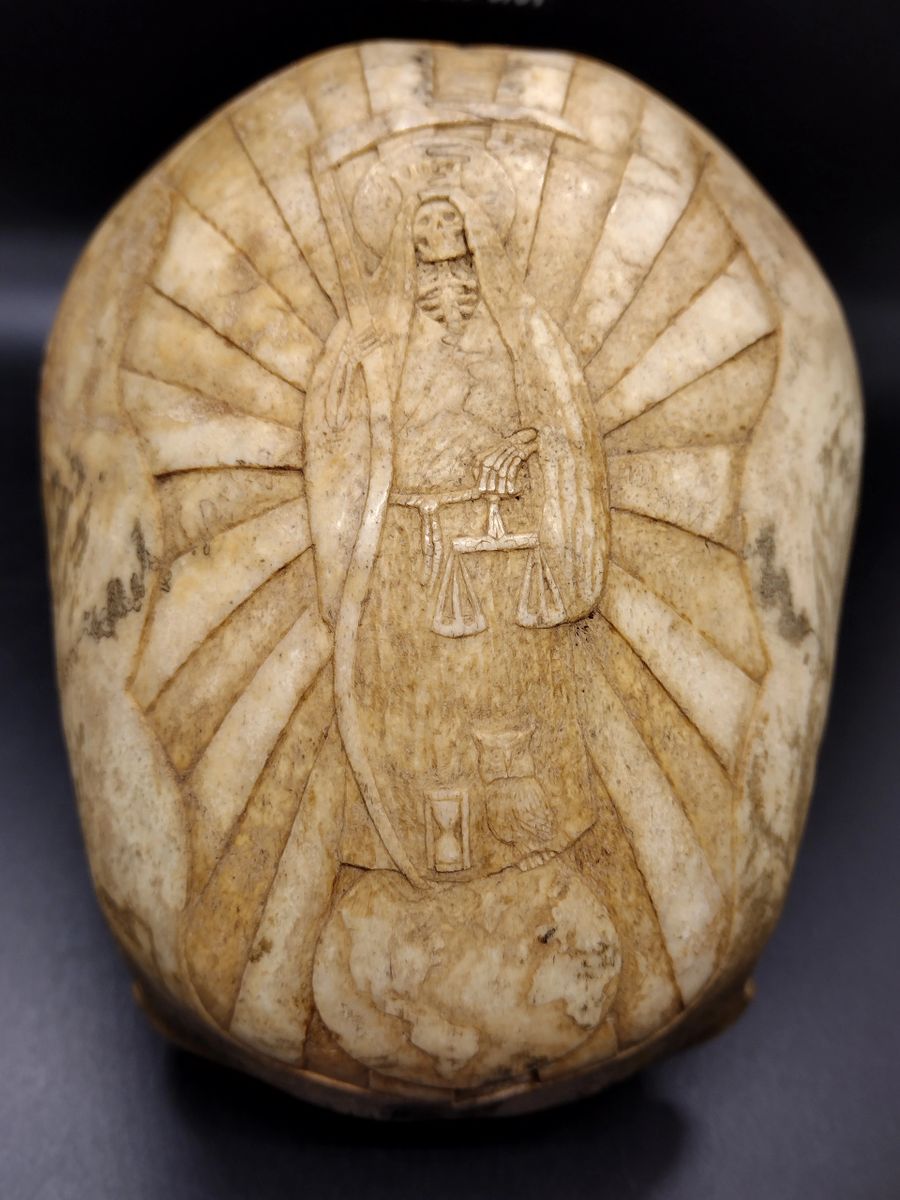 Santa Muerte relief carving on Human Skull
